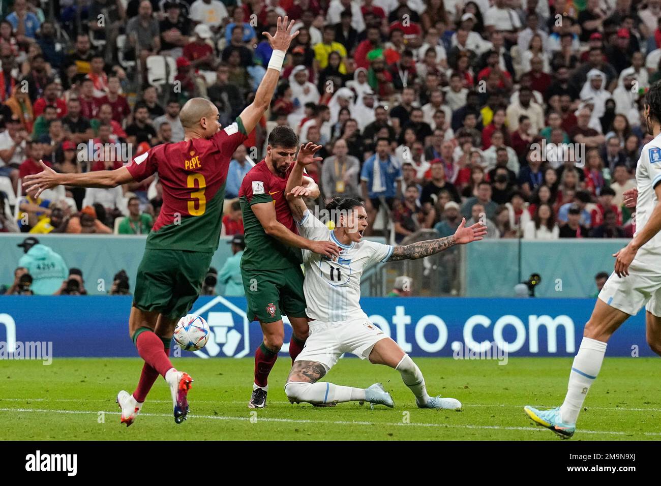 Uruguay's Darwin Nunez, right, is fouled by Portugal's Ruben Dias ...