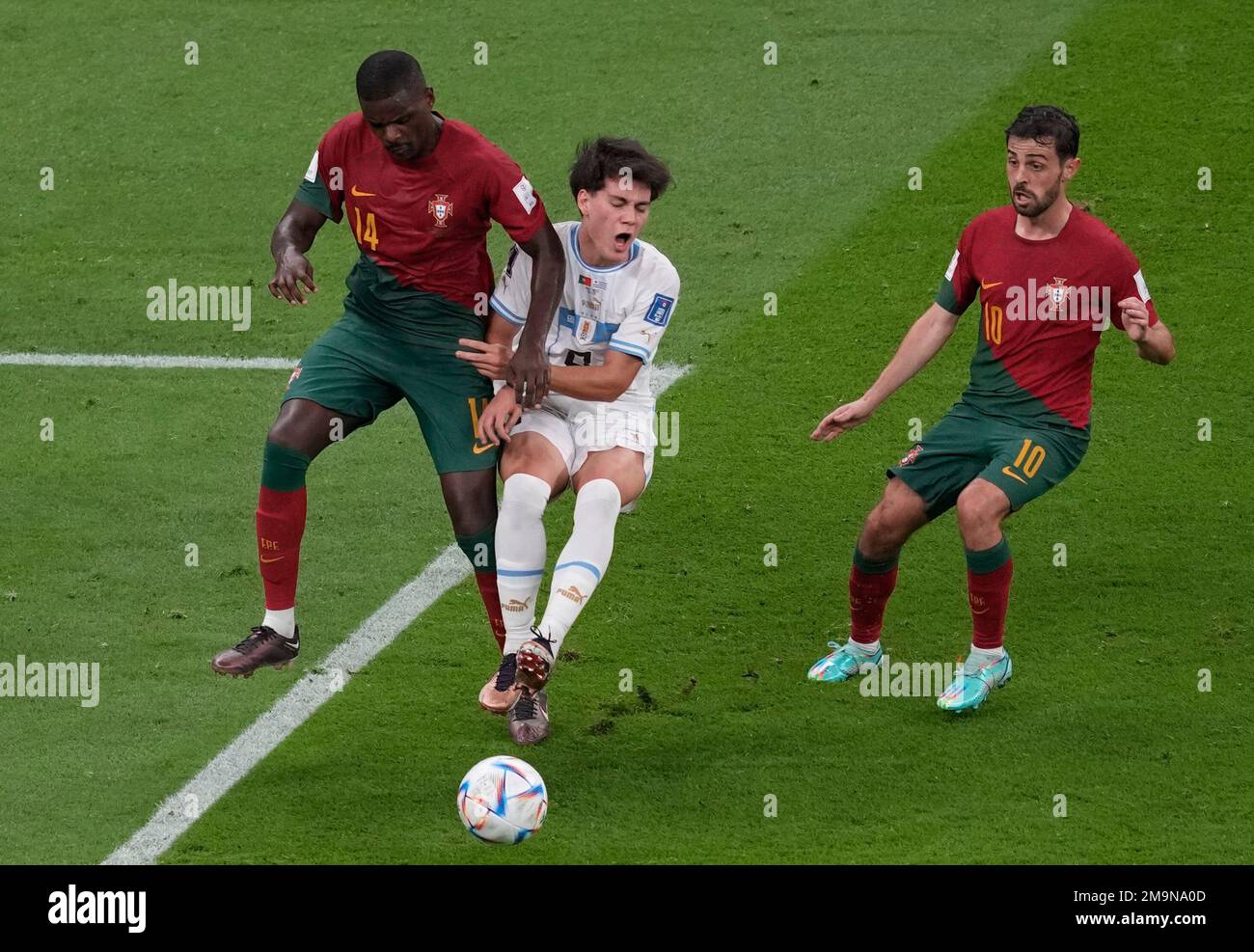 Uruguay's Facundo Pellistri, center, and Portugal's William Carvalho ...