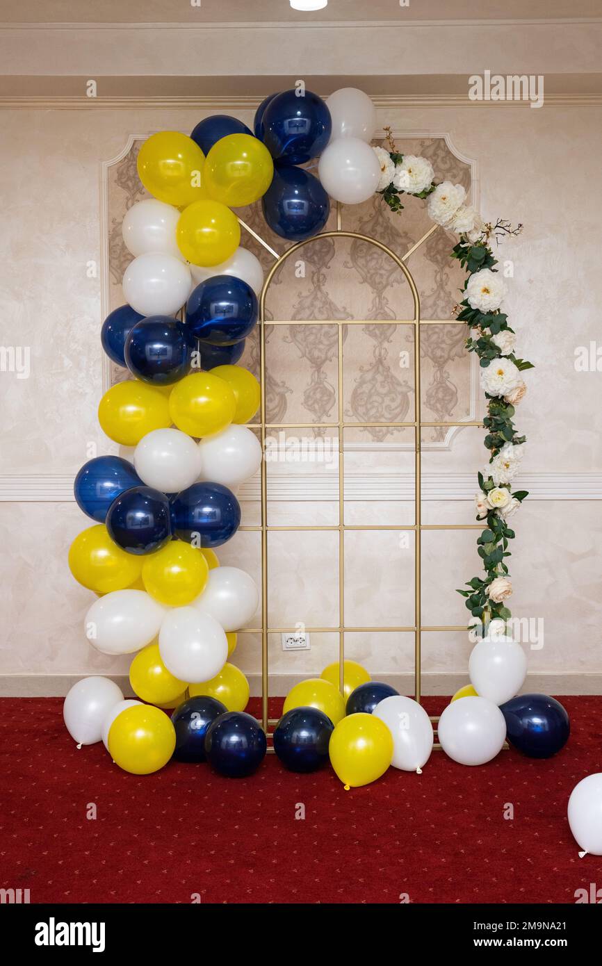 Steel stand decorated with colorful balloons and flowers against the ...