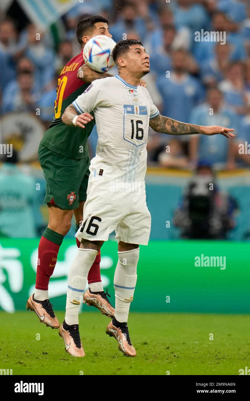 Uruguay's Mathias Olivera and Portugal's Joao Cancelo go for a header ...