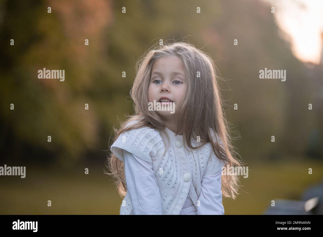Beautiful little child girl walking in a park Stock Photo - Alamy