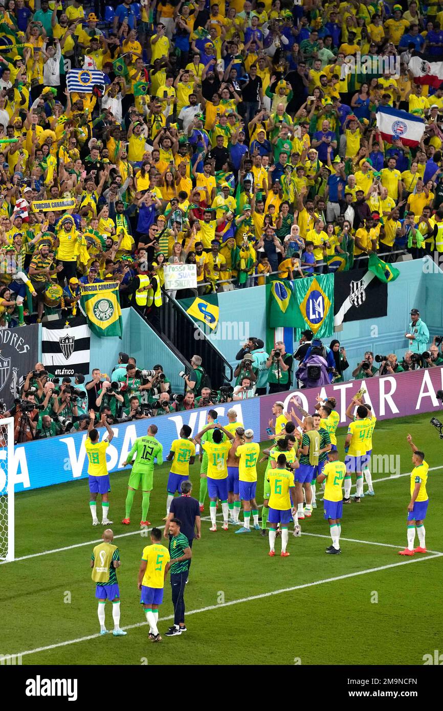 Brazil's players celebrate at the end of the World Cup group G soccer ...