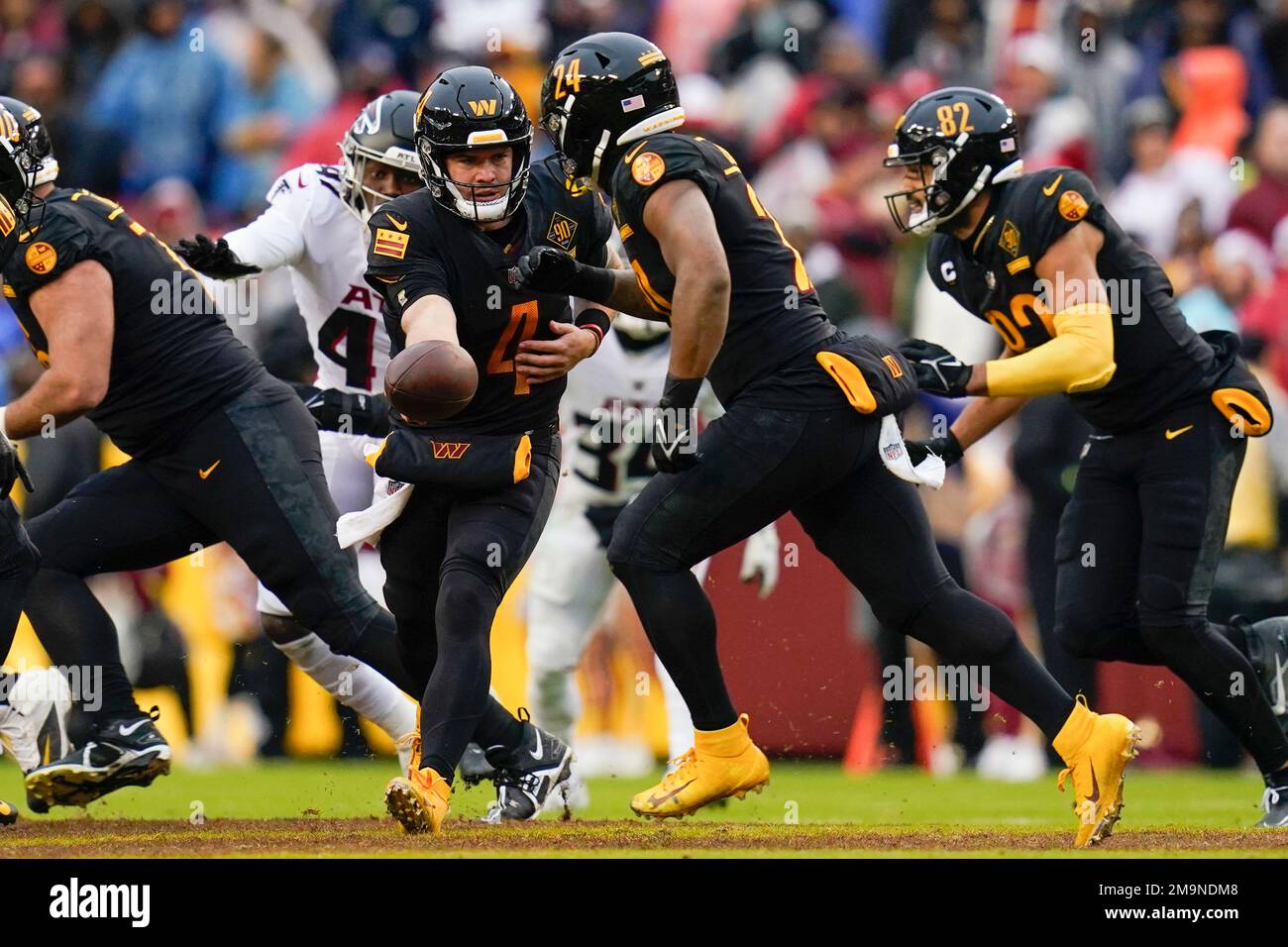 Washington Commanders quarterback Taylor Heinicke (4) hands the ball ...