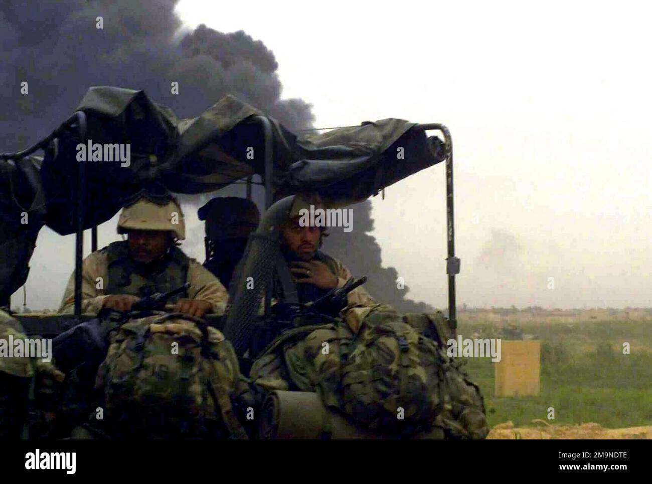 A black plume of smoke looms over the US Marine Corps (USMC) 3rd ...