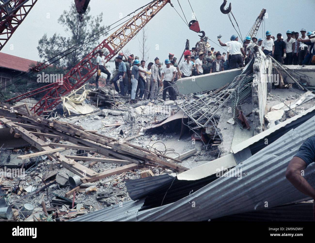 A rescue team inspects the damage caused by the earthquake in Manila ...