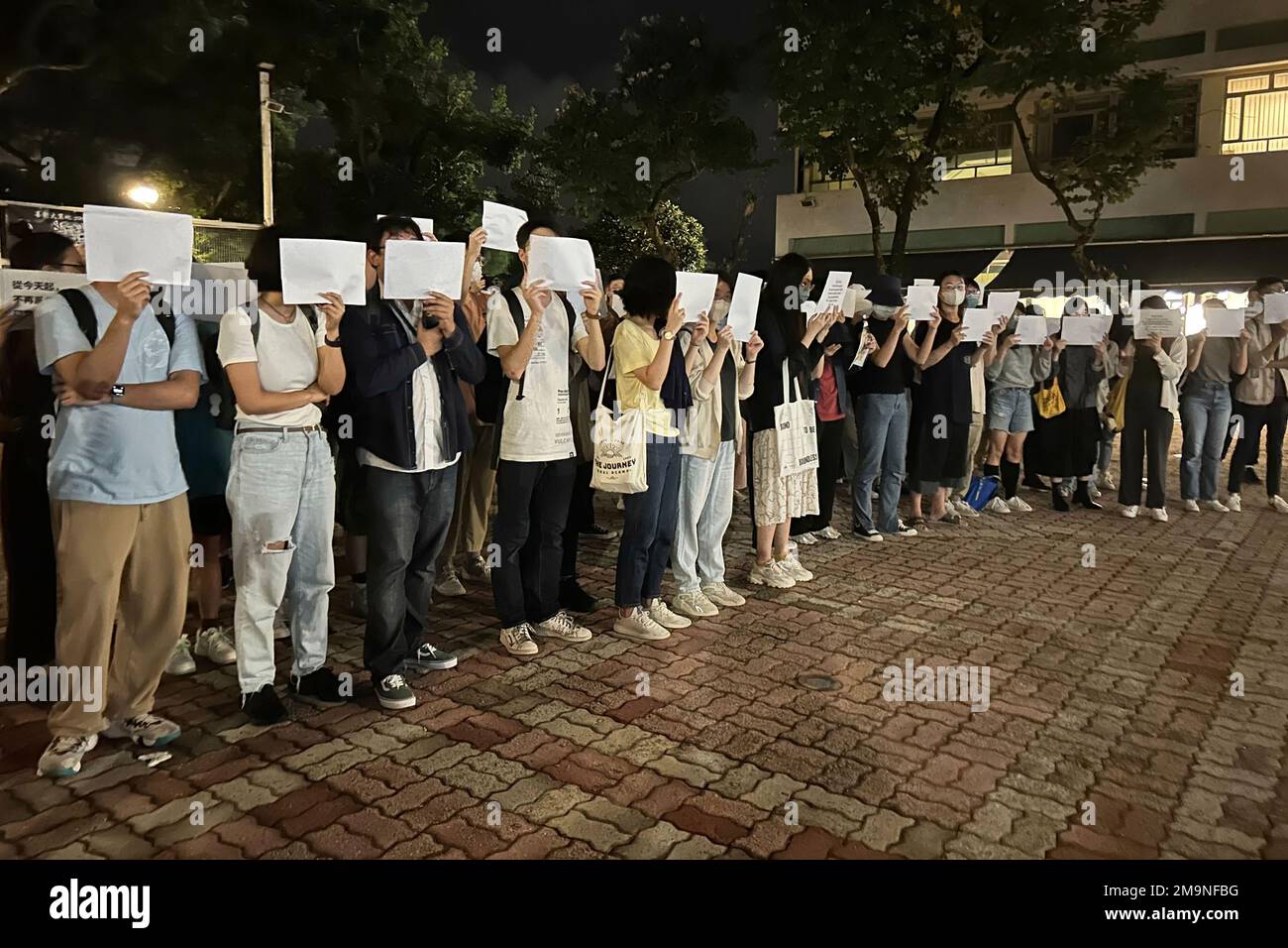 Protesters hold up blank white papers during a commemoration for ...