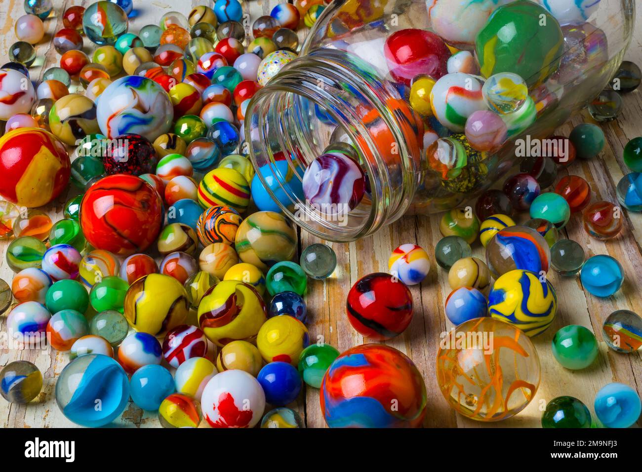 Jar Spilling Colorful Marbles Stock Photo - Alamy
