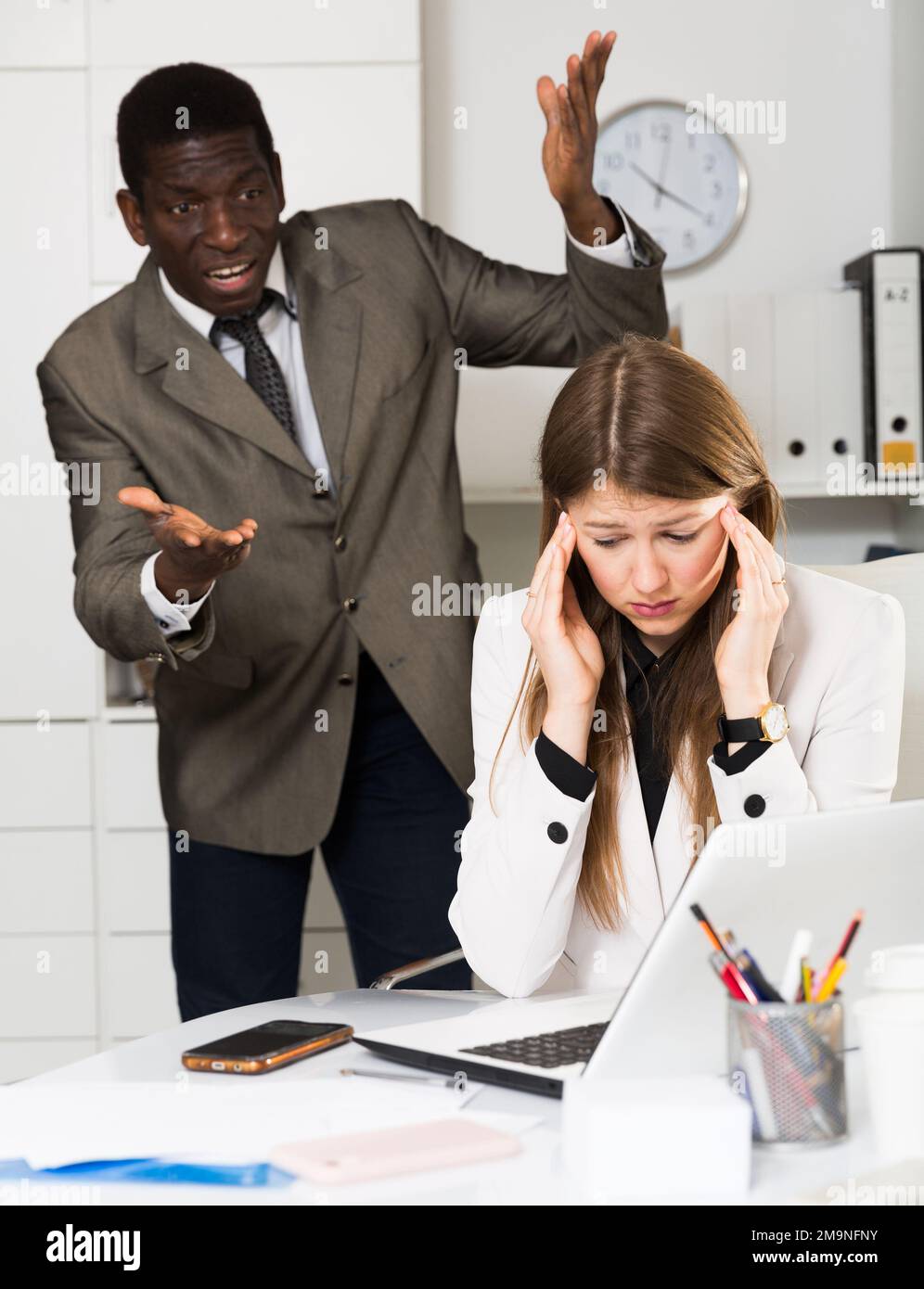 Upset woman with angry boss Stock Photo - Alamy