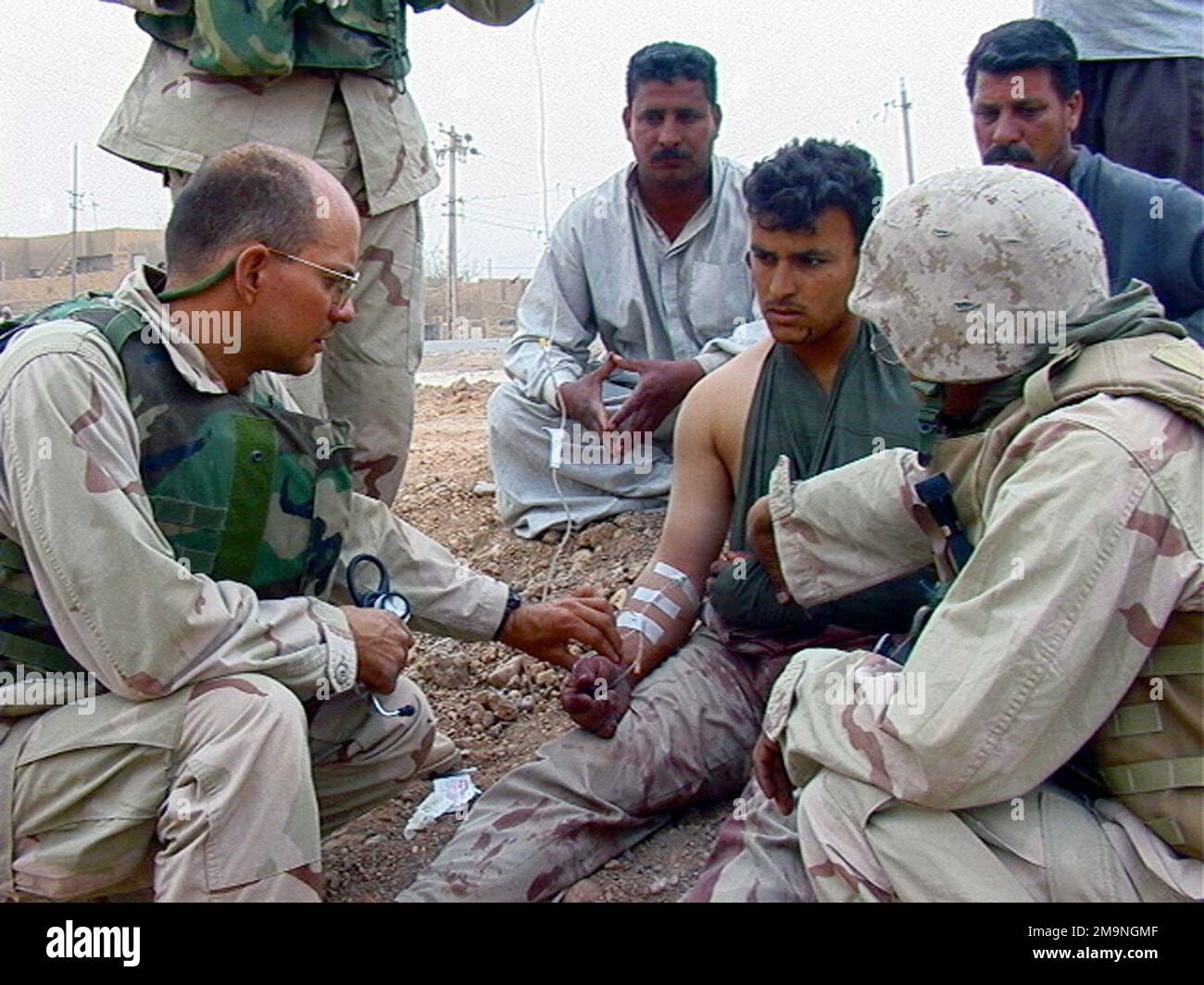 US Navy (USN) Lieutenant Commander (LCDR) Bryan Schumacher (kneeling ...