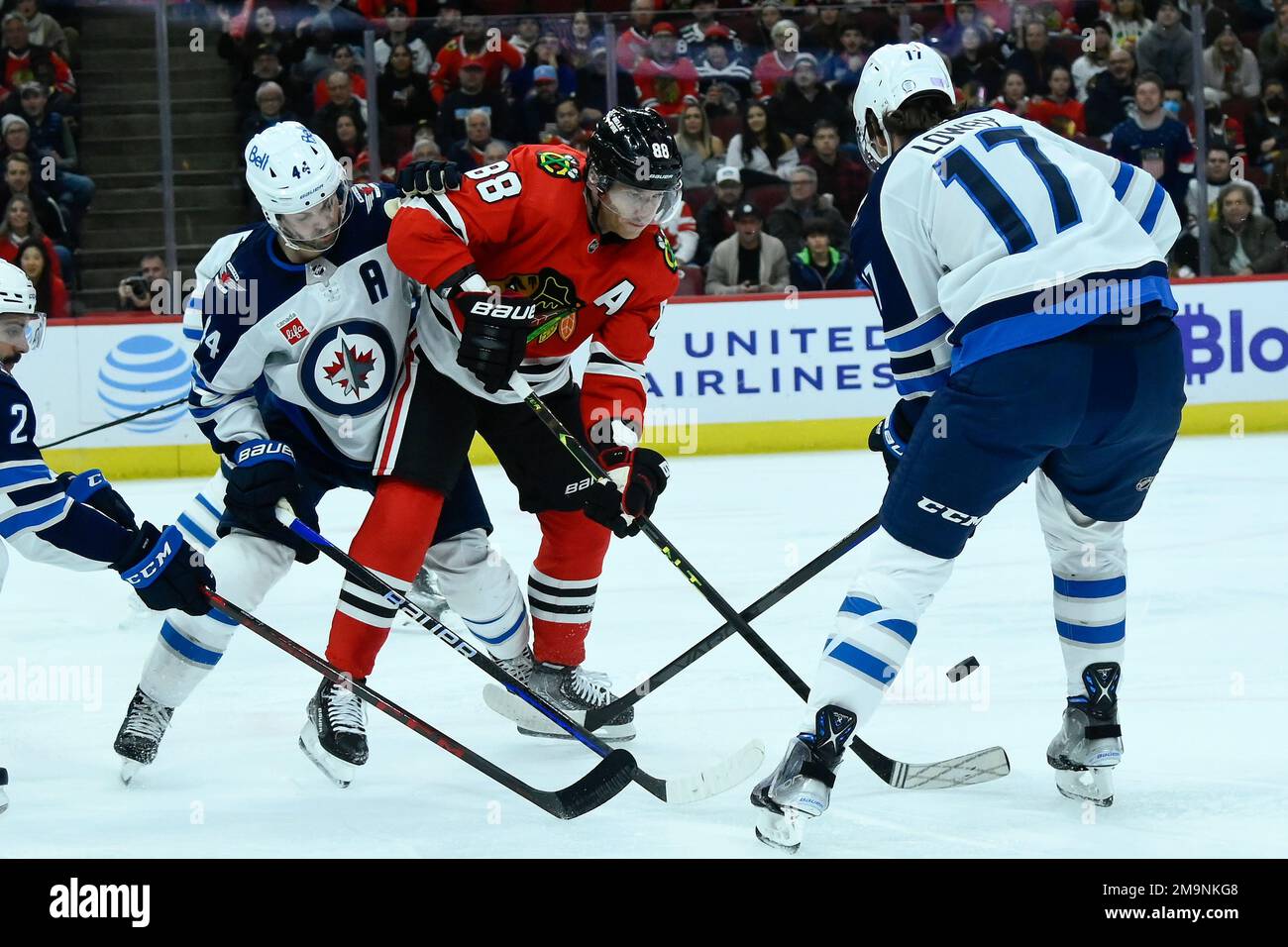 Chicago Blackhawks right wing Patrick Kane passes the puck away from ...