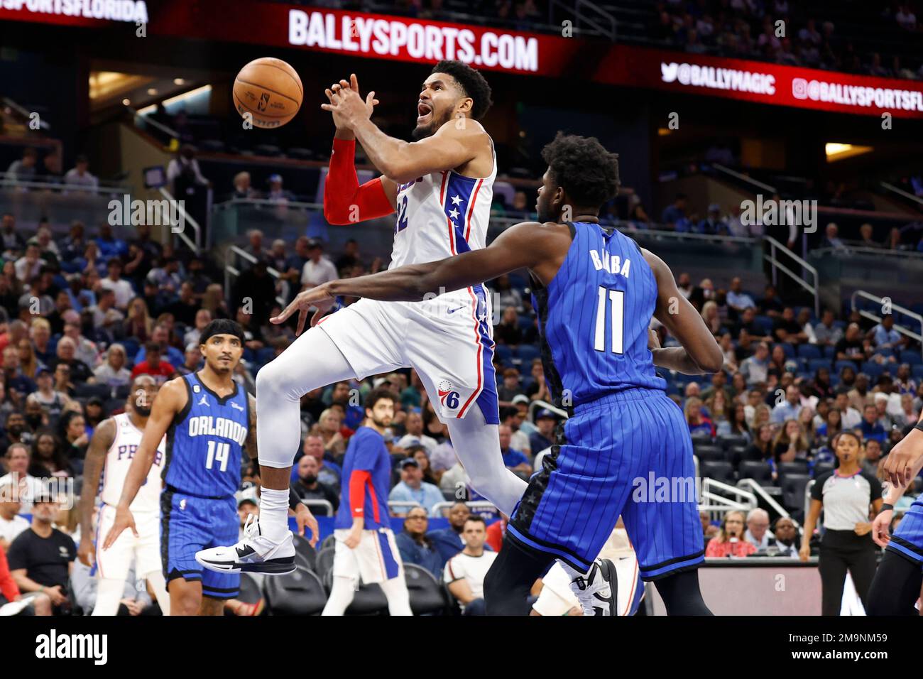 Orlando Magic center Mo Bamba fouls Philadelphia 76ers forward Tobias Harris during the first ...