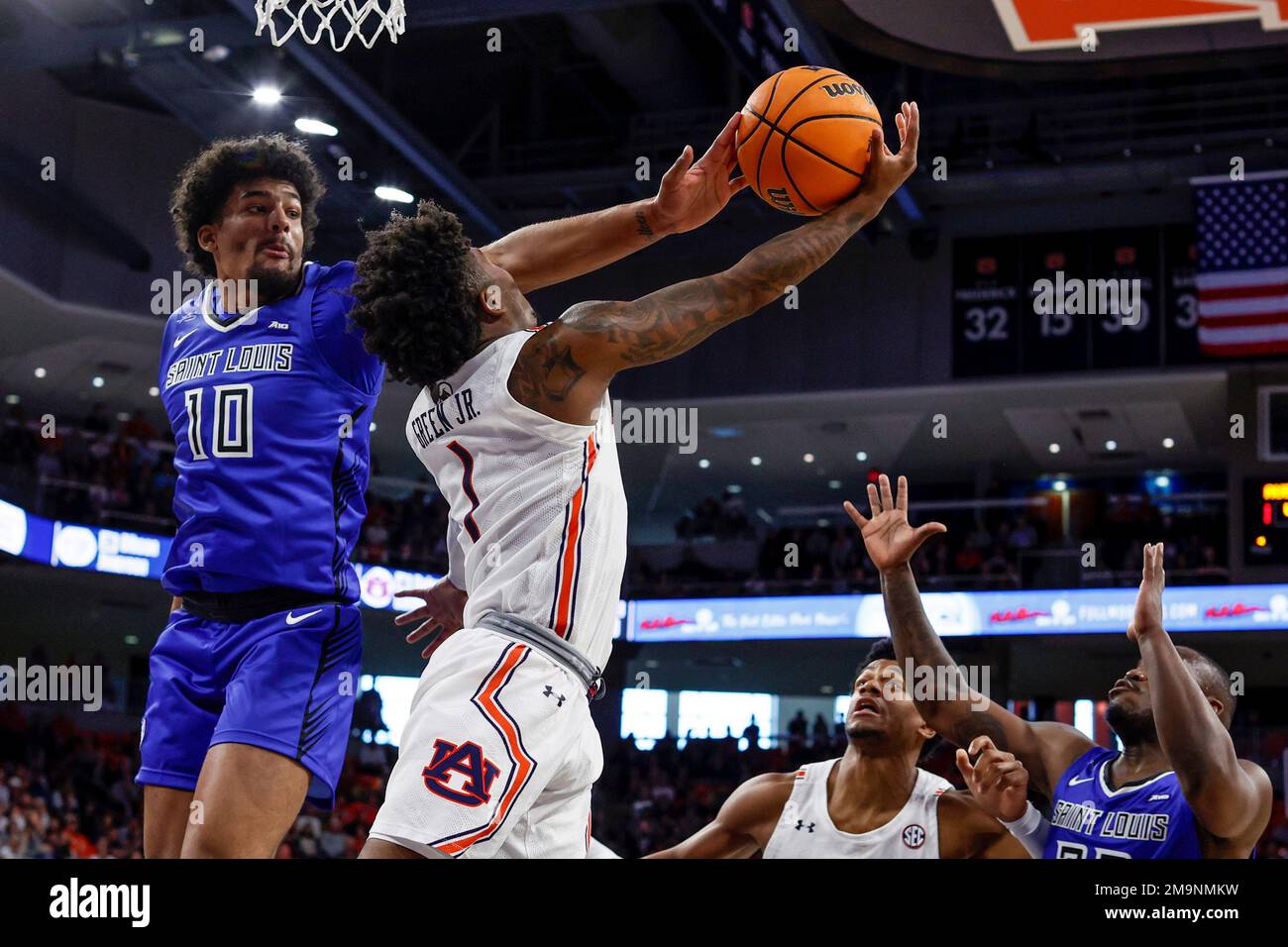 Saint Louis forward Jake Forrester (10) blocks the shot of Auburn guard ...