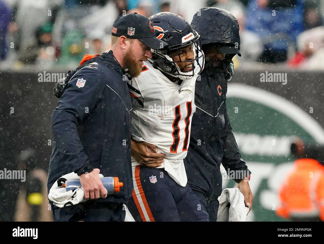 Chicago Bears wide receiver Darnell Mooney (11) is helped off the field ...