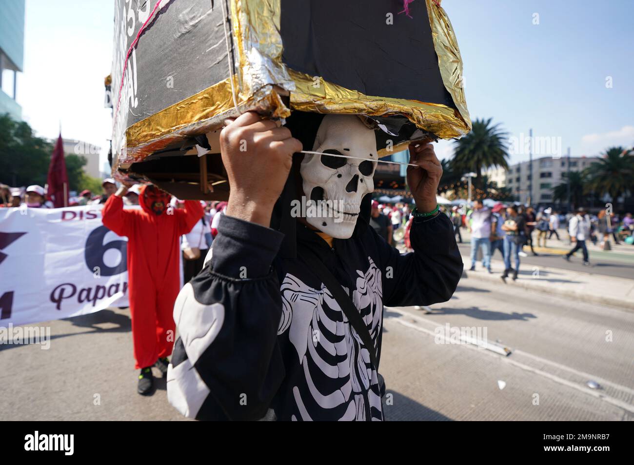 A man wears a skeleton costume during a march to support Mexican ...