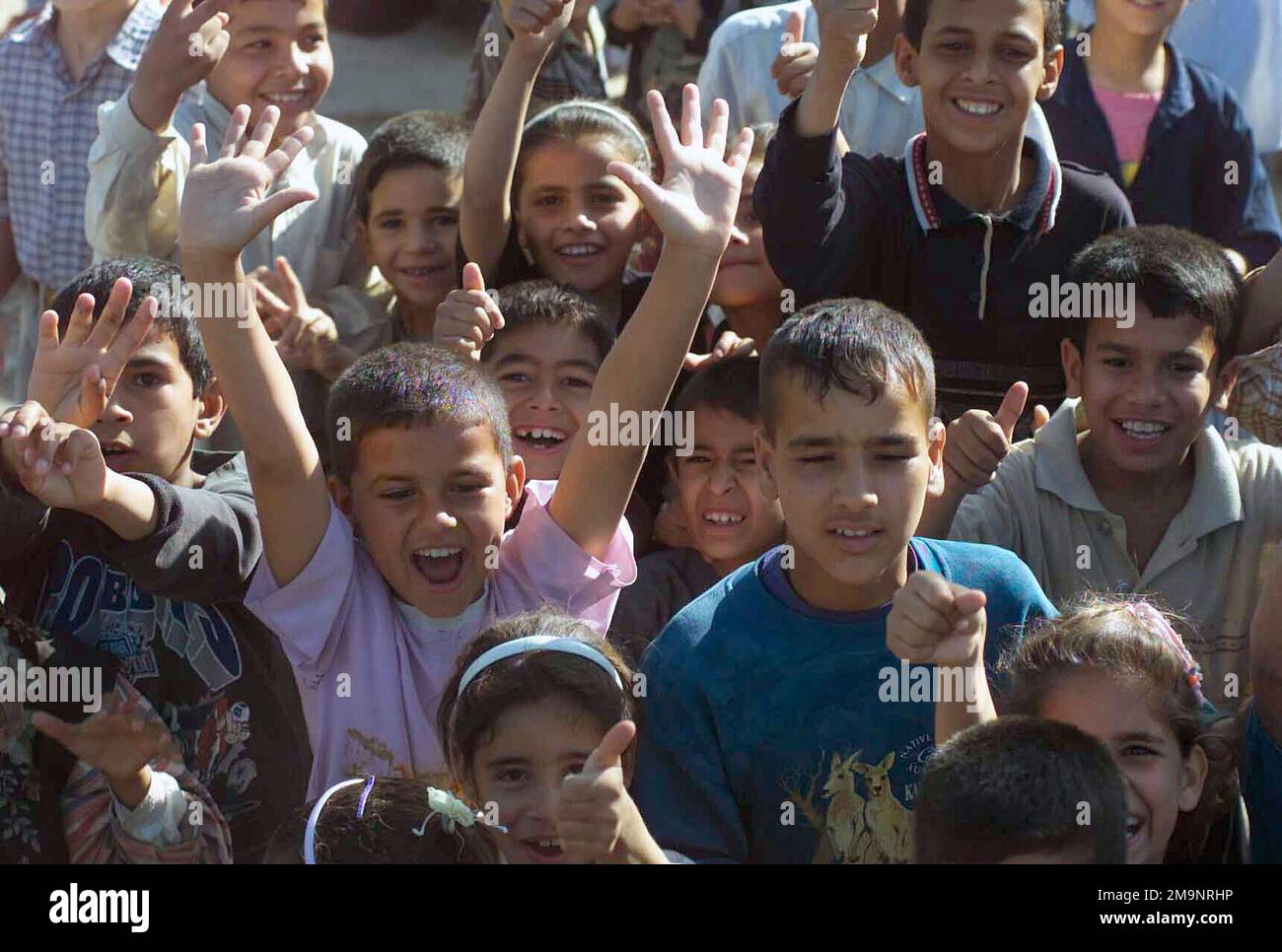 Newly liberated Iraqi children gather in the streets and eagerly greet ...
