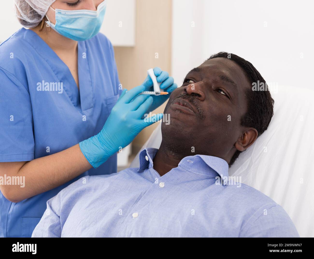 Man getting procedure of injection for face skin tightening Stock Photo ...