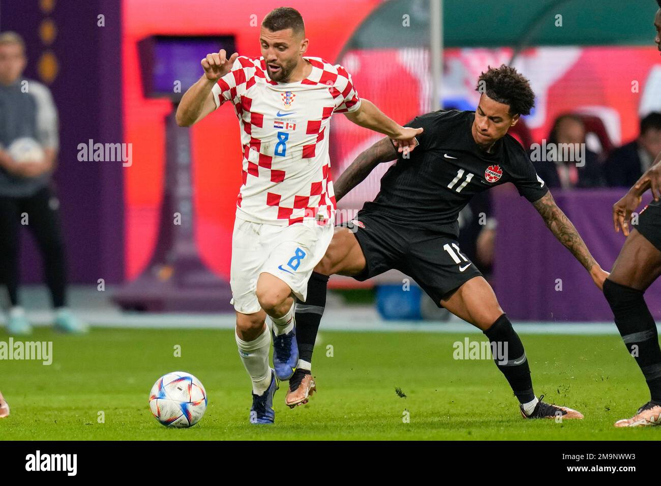 Croatia's Mateo Kovacic, left, is challenged by Canada's Tajon Buchanan ...