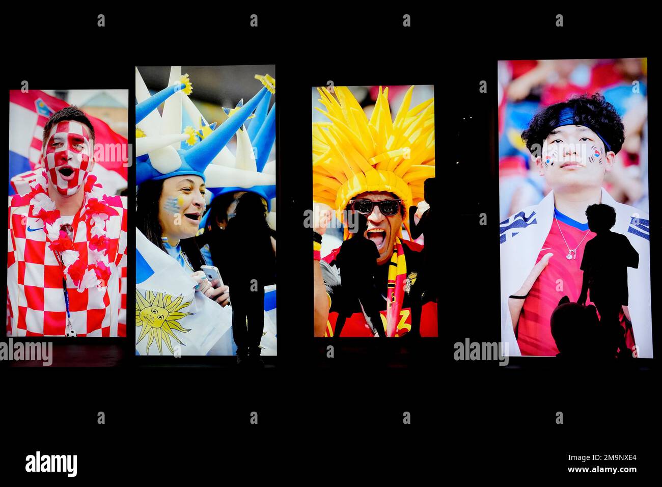 Soccer fans pose in front of posters during the World Cup group F ...