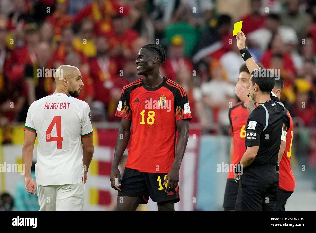 Referee Cesar Ramos of Mexico shows the yellow card to Belgium's Amadou ...