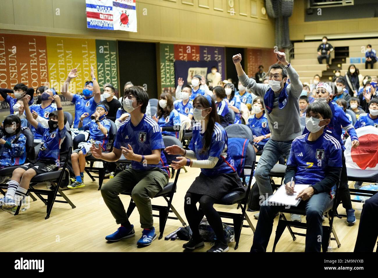 People react as they watch on a live stream of the World Cup group E ...