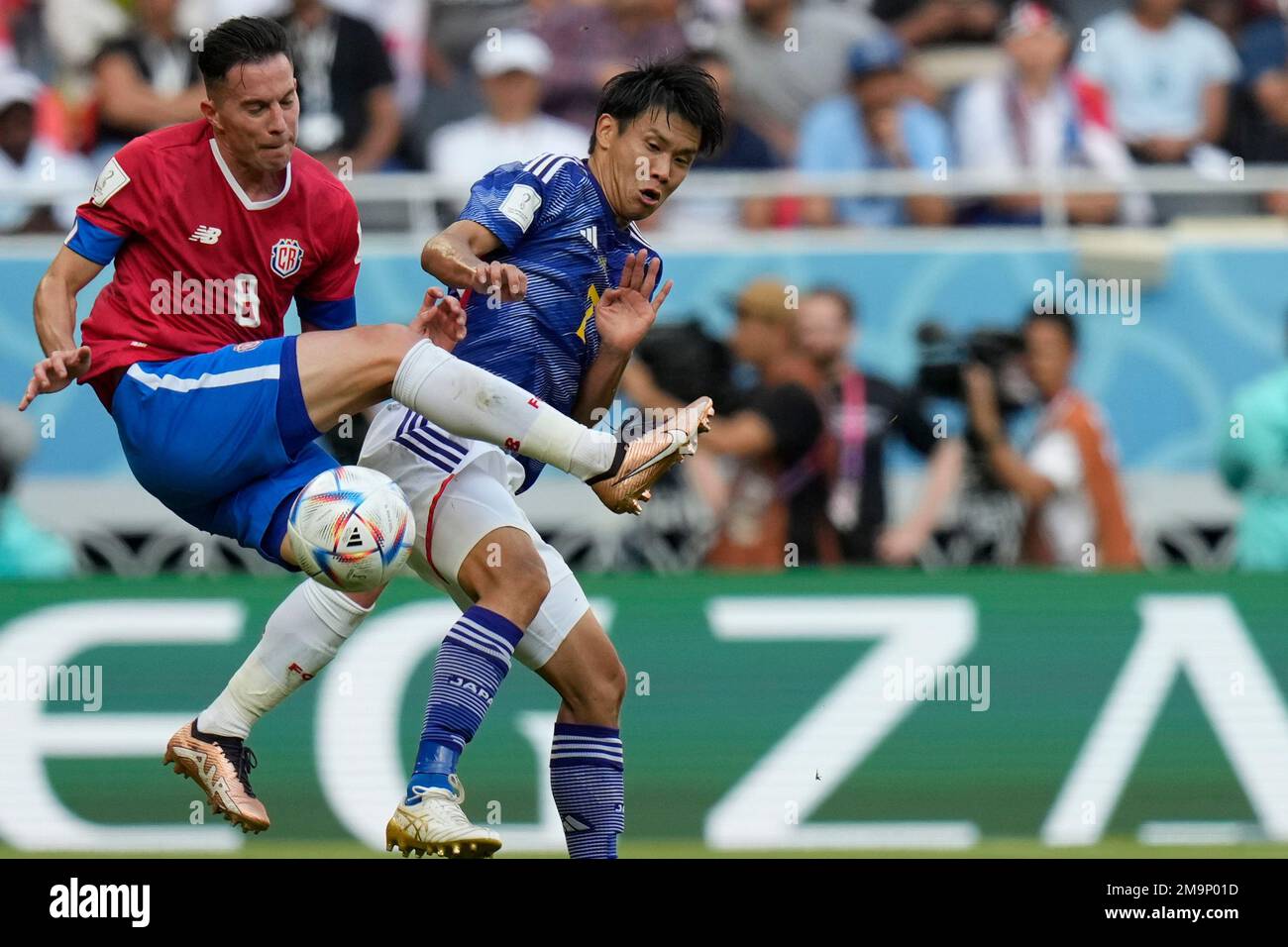 Costa Rica's Bryan Oviedo, left, and Japan's Miki Yamane challenge for the ball during the World ...