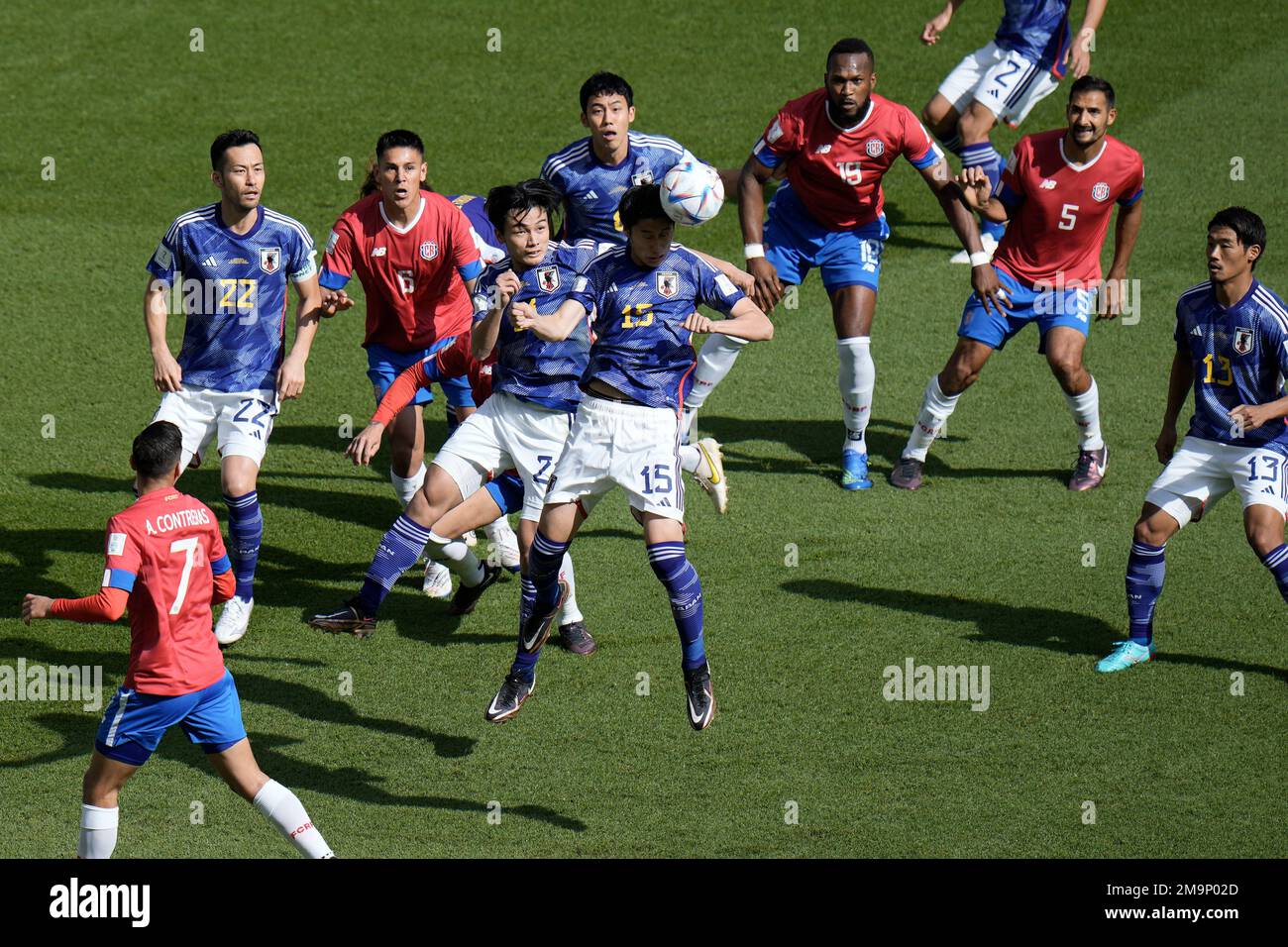Japan's Daichi Kamada, center, heads to clear the ball during the World ...