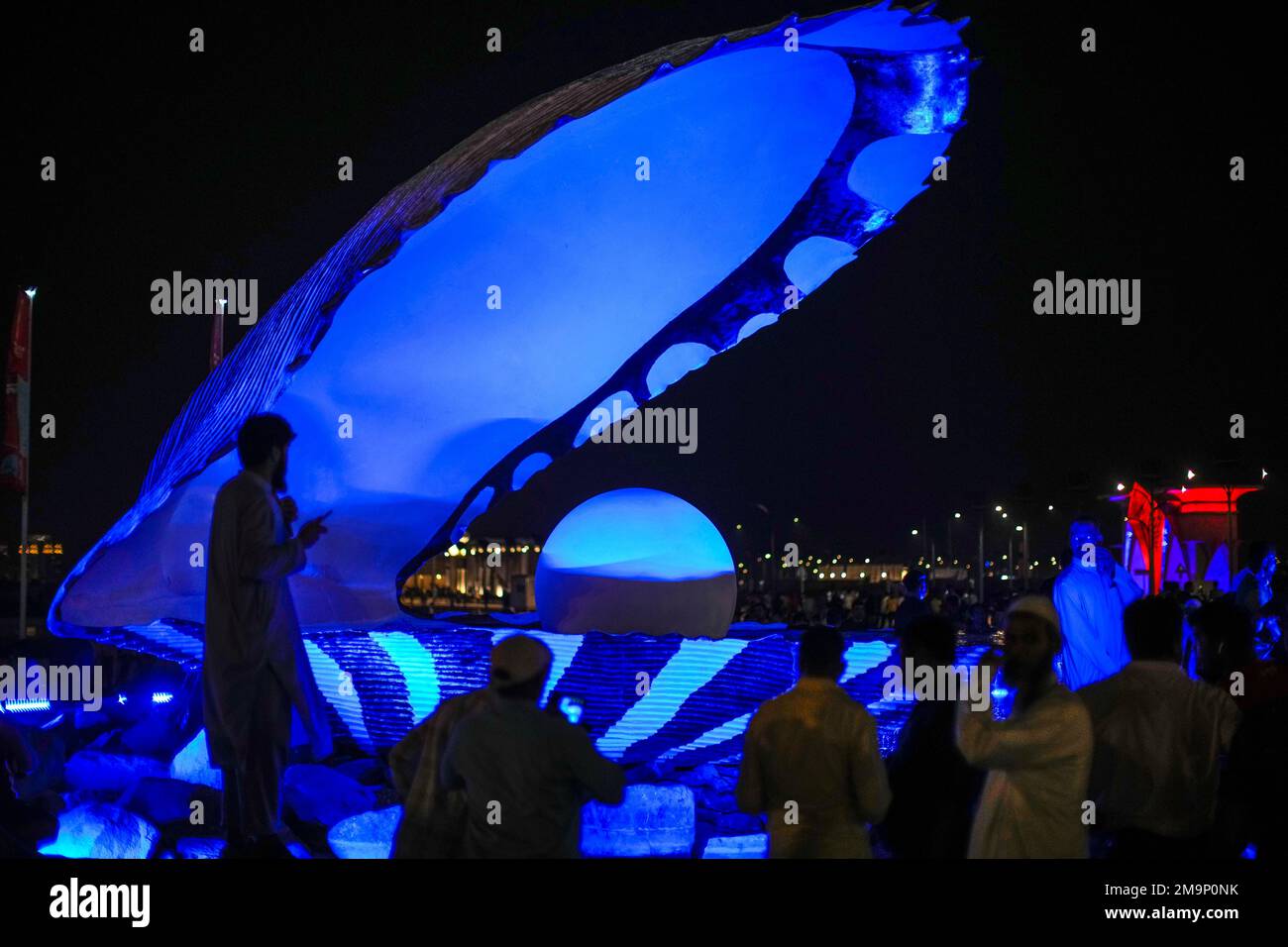 People take photographs of the Pearl monument at the Corniche sea ...