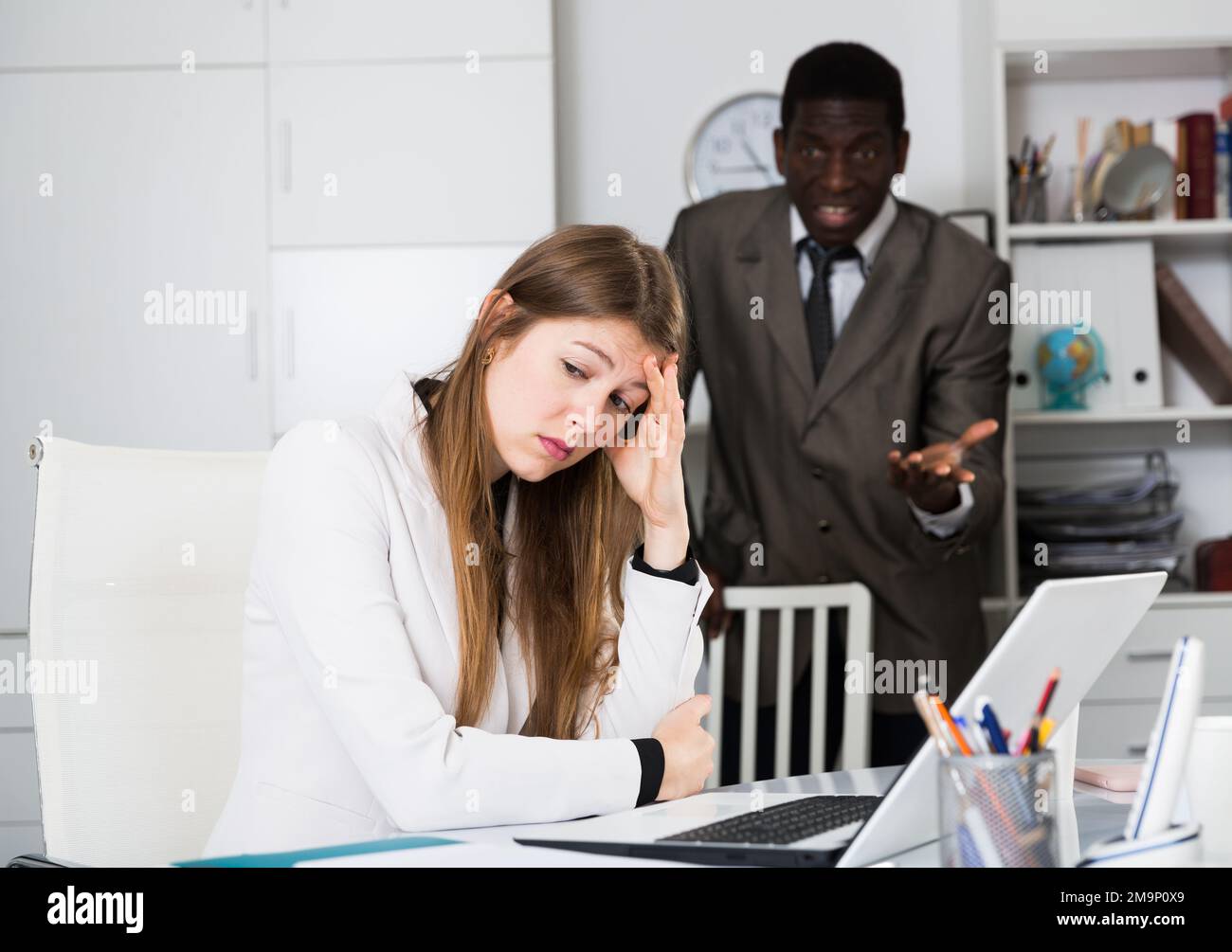 Upset woman with angry boss Stock Photo - Alamy