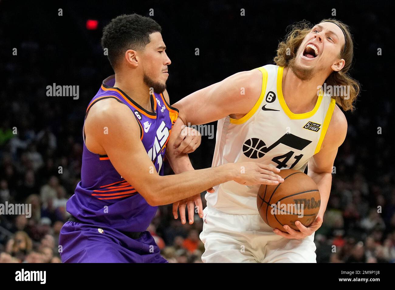 Utah Jazz forward Kelly Olynyk (41) gets fouled by Phoenix Suns guard Devin Booker during the ...