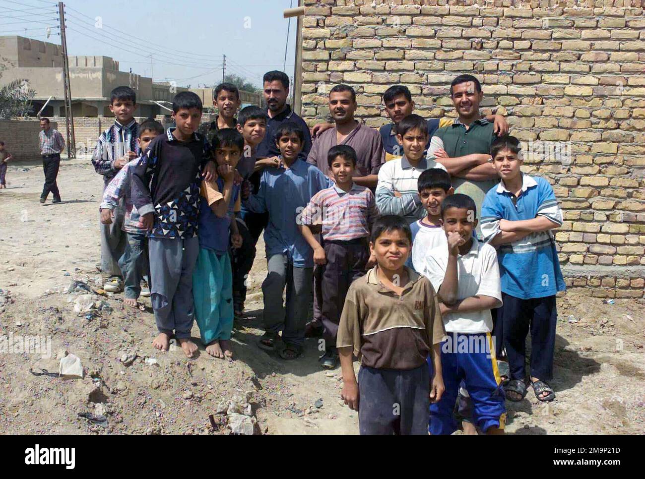 A group of local Iraqi civilians pose for photograph along side a ...