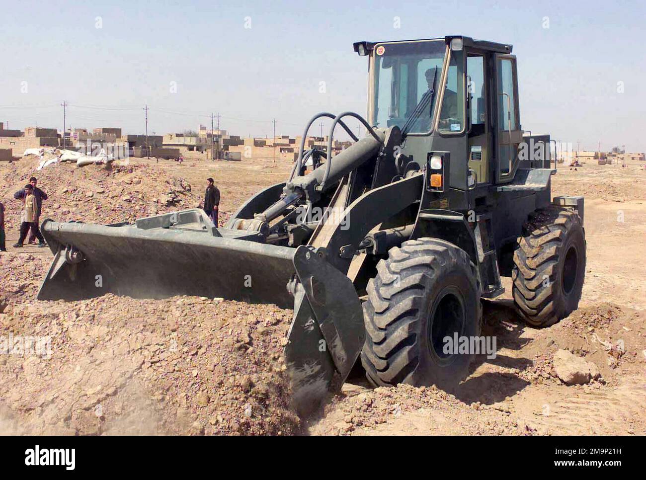 Local Iraqi children look on as a US Marine Corps (USMC) Marine ...