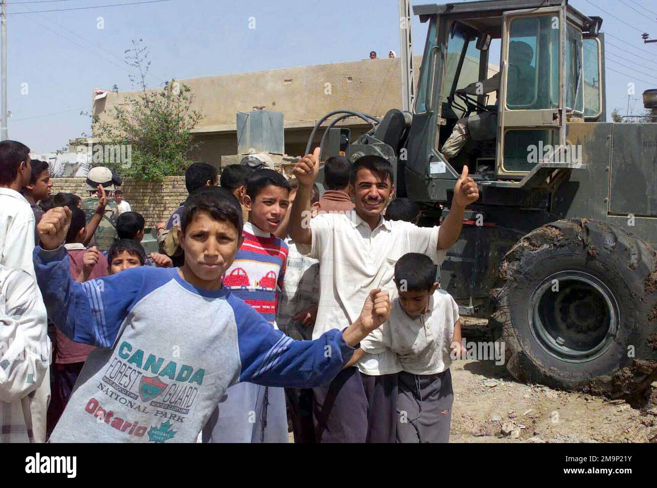 A group of local Iraqi children show their support as a US Marine Corps ...