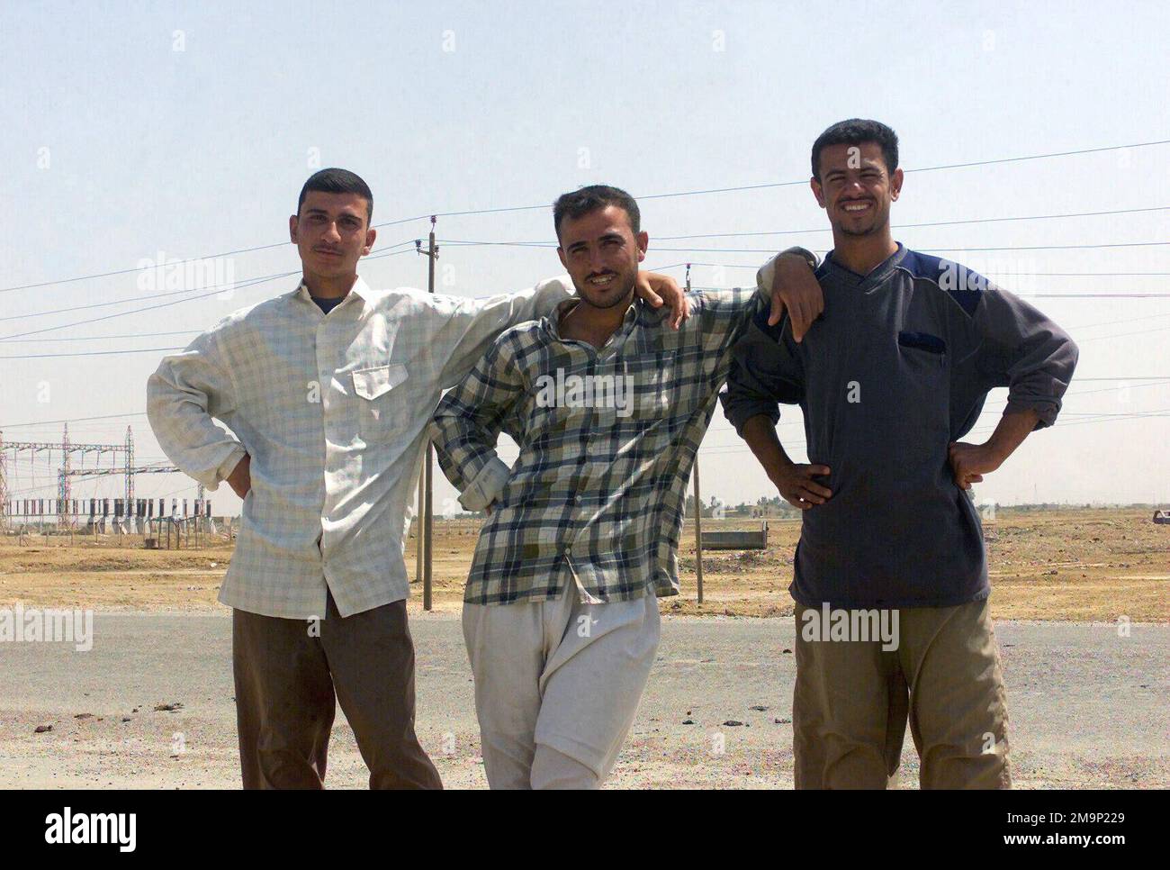 Three local Iraqi civilians pose for photograph along side a major ...