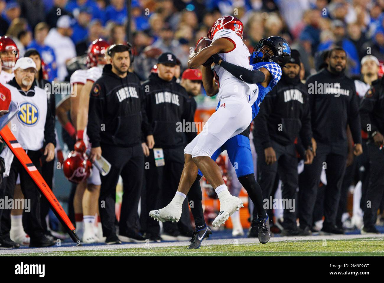Kentucky defensive back Carrington Valentine, right, tackles Louisville ...