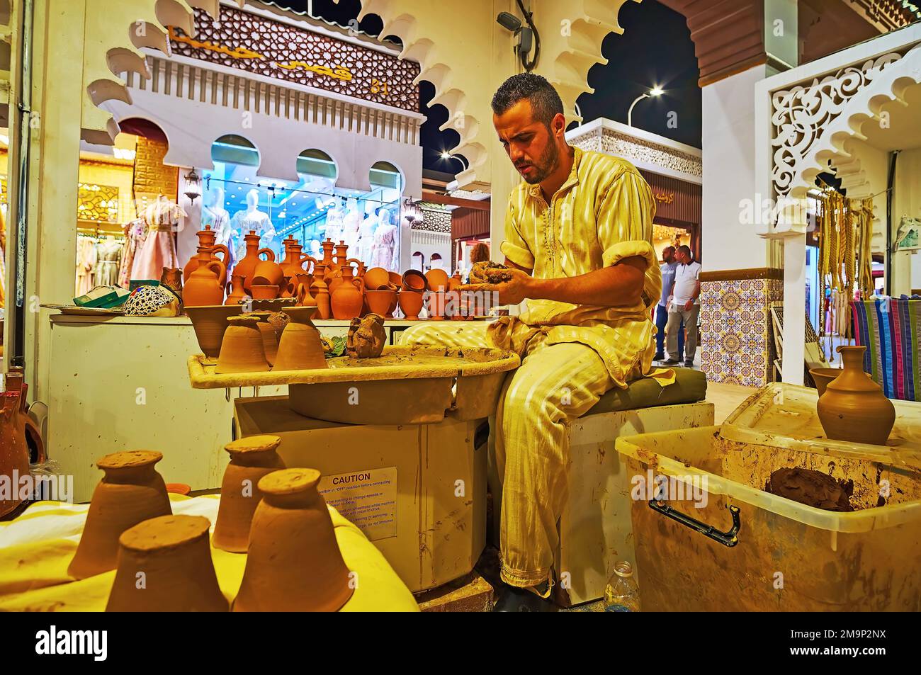 DUBAI, UAE - MARCH 6, 2020: The potter creates the clay pot at potter's ...