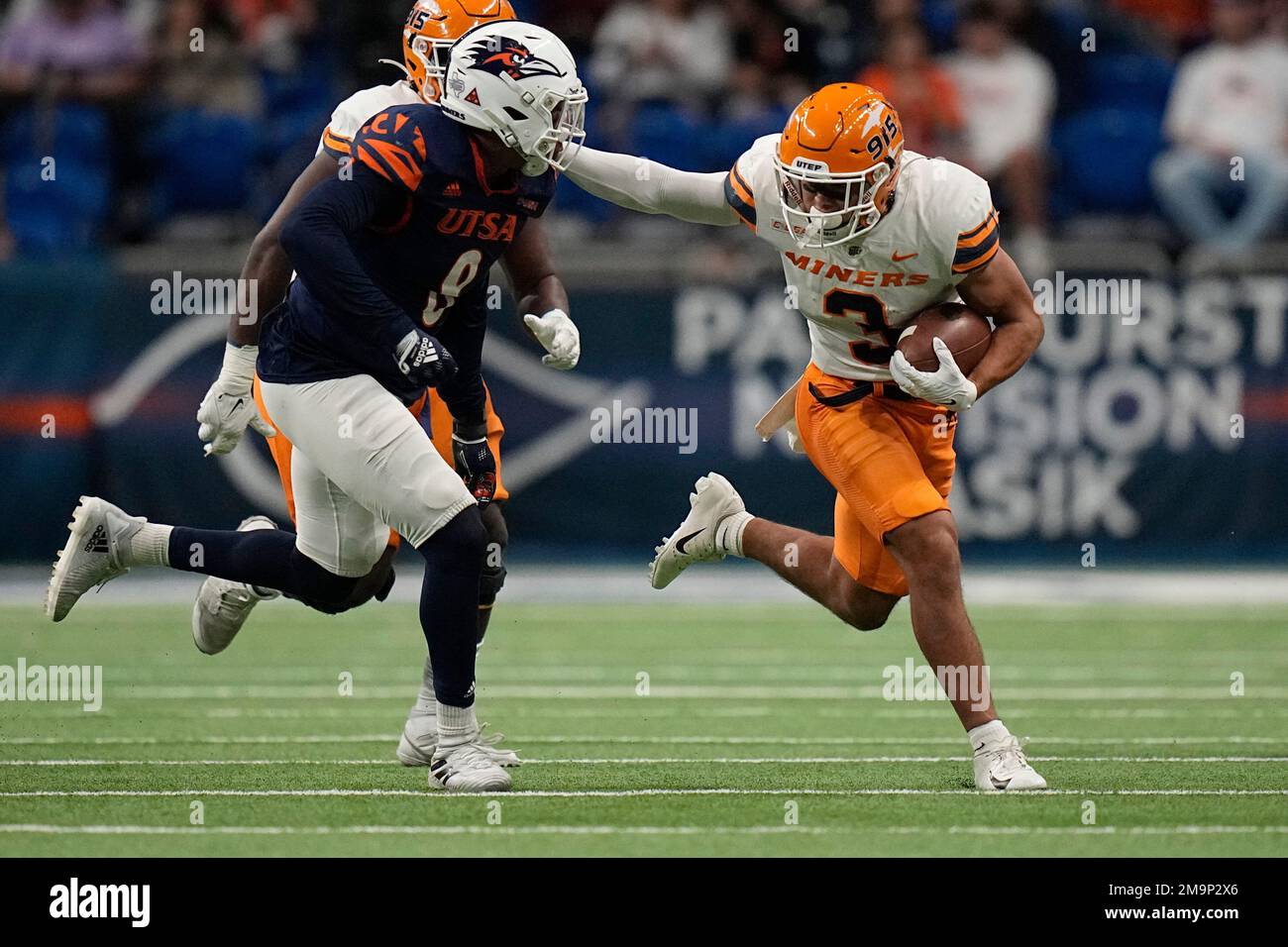 UTEP running back Reynaldo Flores (3) runs past UTSA defensive lineman ...