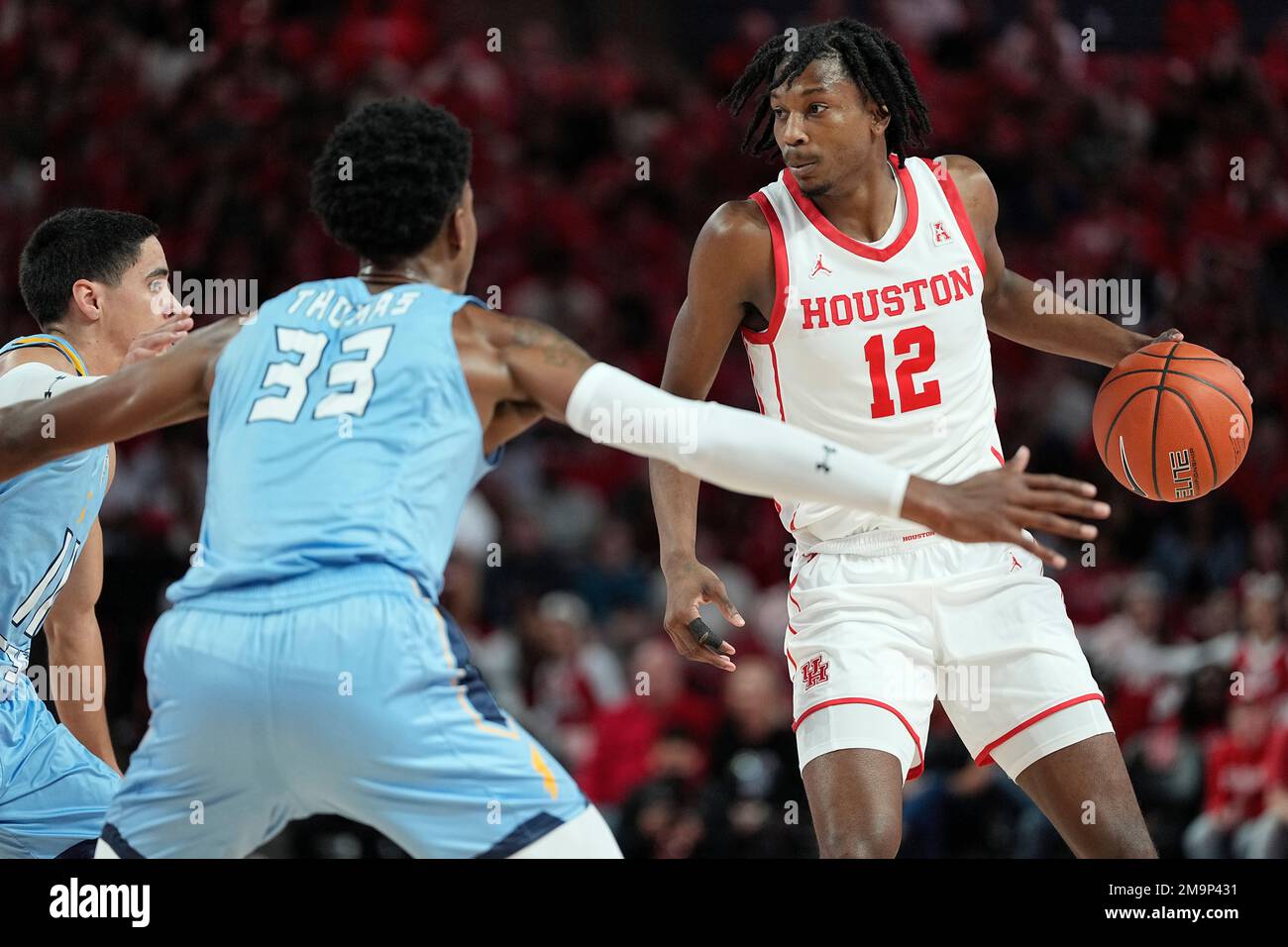 Houston guard Tramon Mark (12) is double-teamed by Kent State guard ...