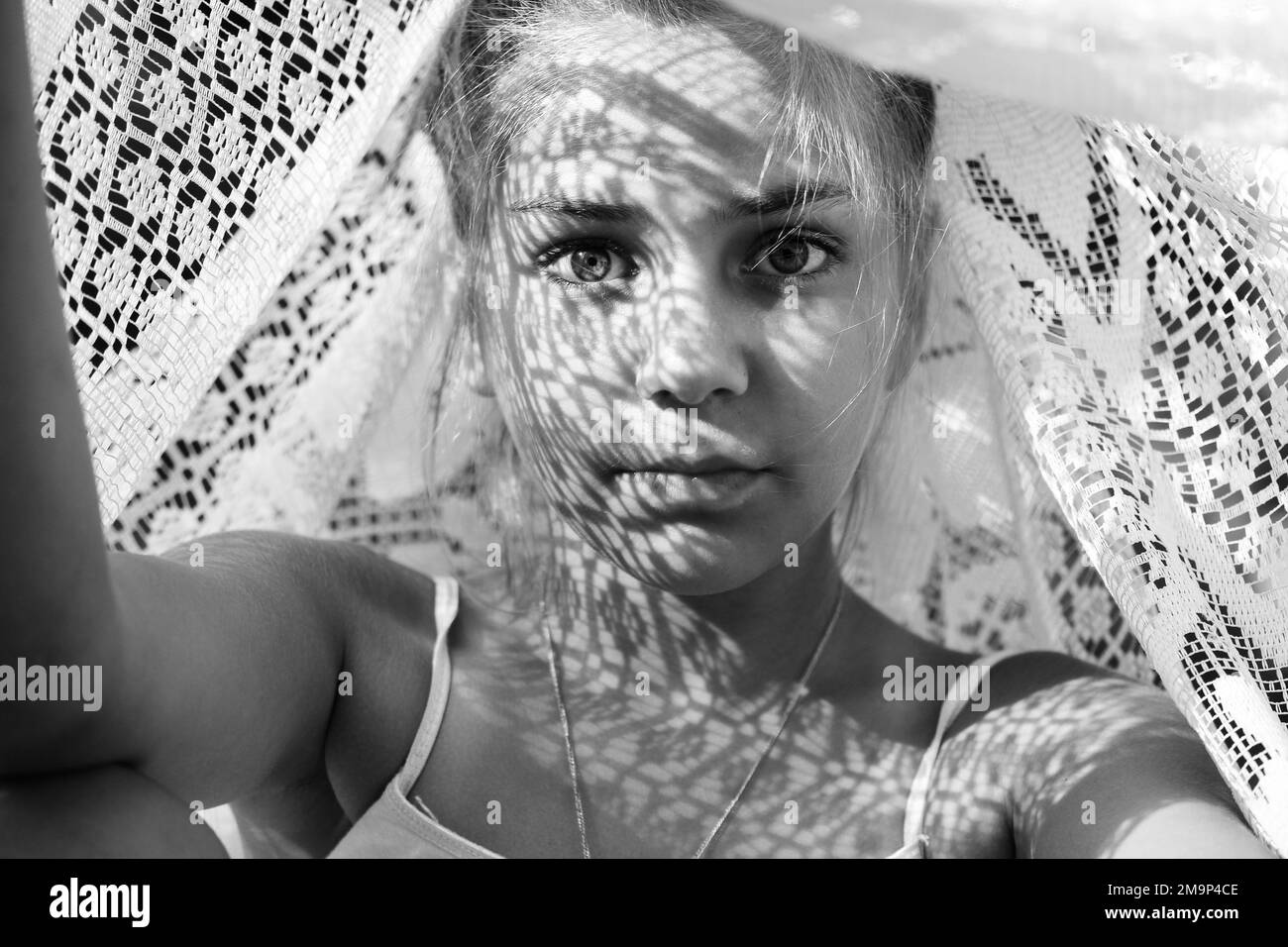 Beautiful swarthy oriental teenage girl is hiding under white shawl for ...