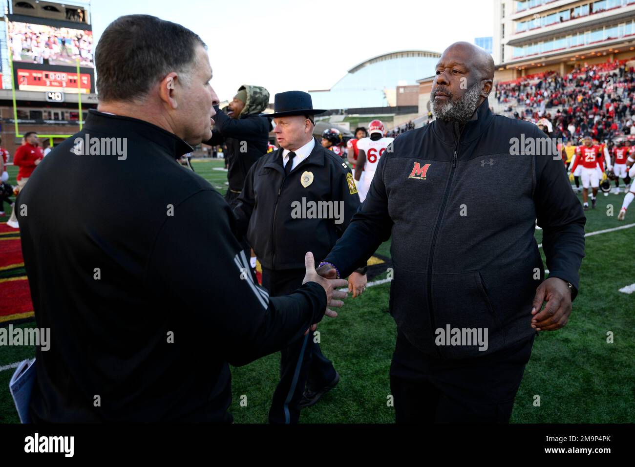 Maryland head coach Mike Locksley, right, shakes hands with Rutgers ...