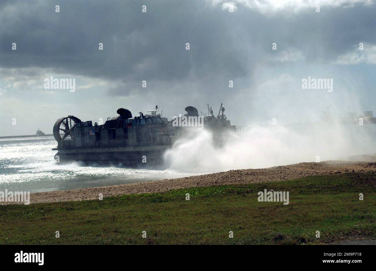 A US Navy (USN) Landing Craft, Air Cushioned (LCAC) leaves the beach at ...