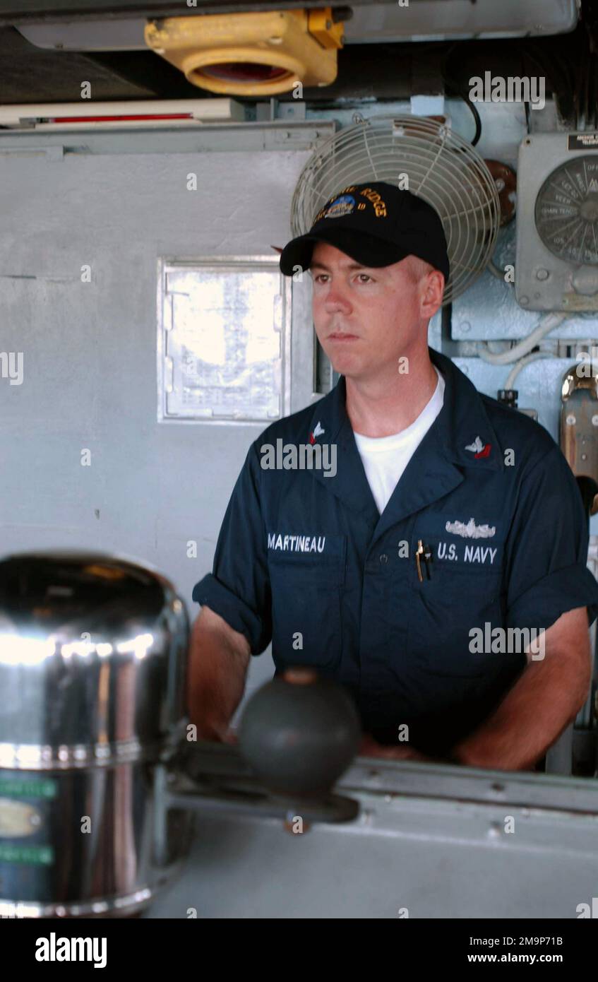 US Navy (USN) Quarter MASTER Second Class (QM2) Greg Martineau stands ...
