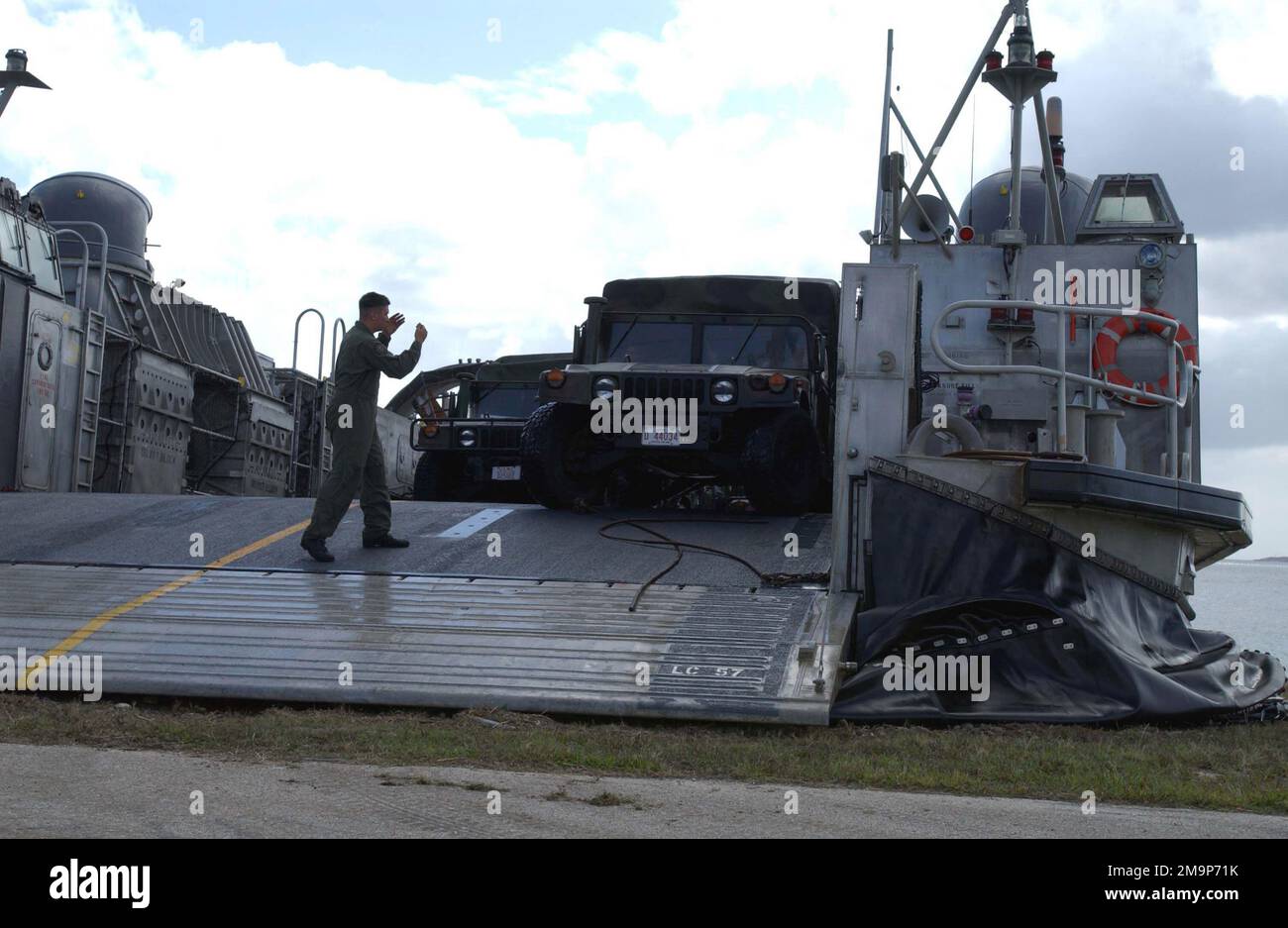 A US Navy (USN) crewmember on board a USN Landing Craft, Air Cushioned ...