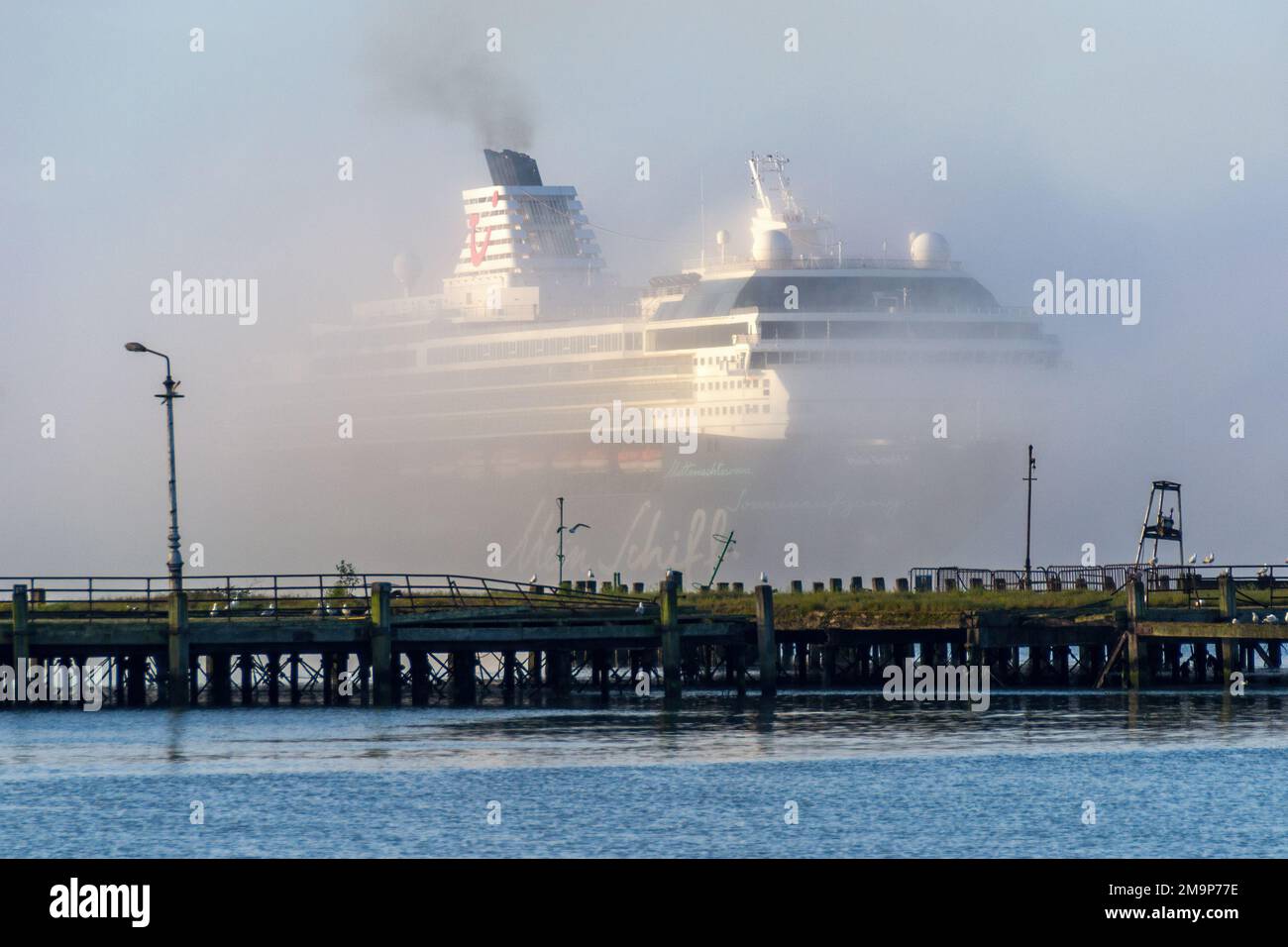 A cruise ship entering port in foggy conditions Stock Photo - Alamy