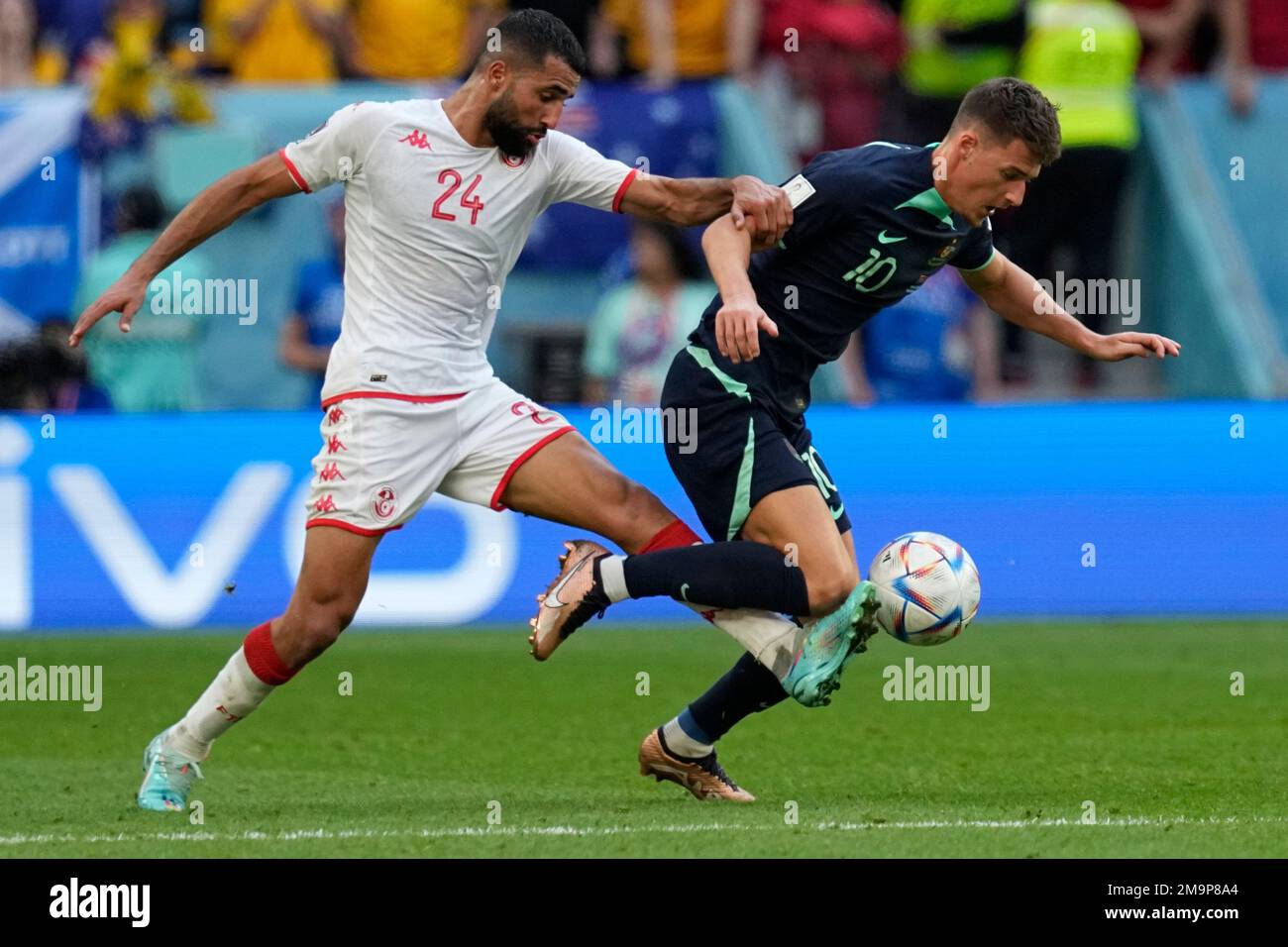 Tunisia's Ali Abdi, left and Australia's Ajdin Hrustic vie for the ball ...