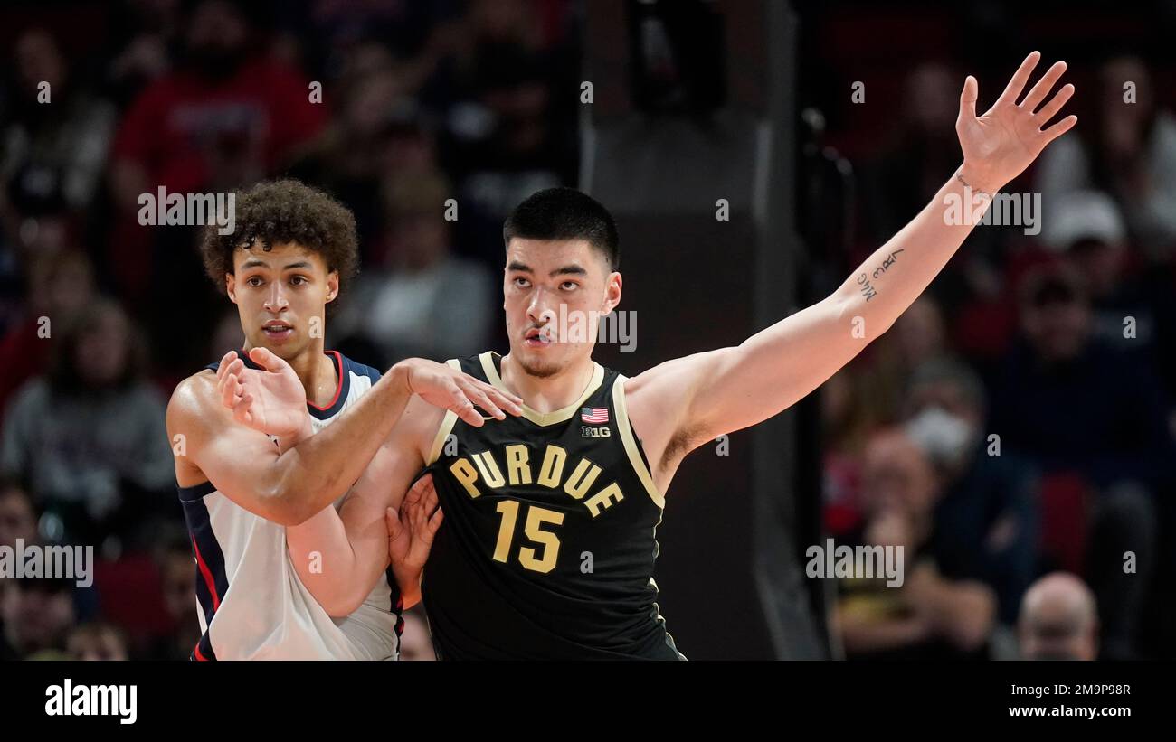 Gonzaga forward Anton Watson, left, guards Purdue center Zach Edey (15) during the second half ...