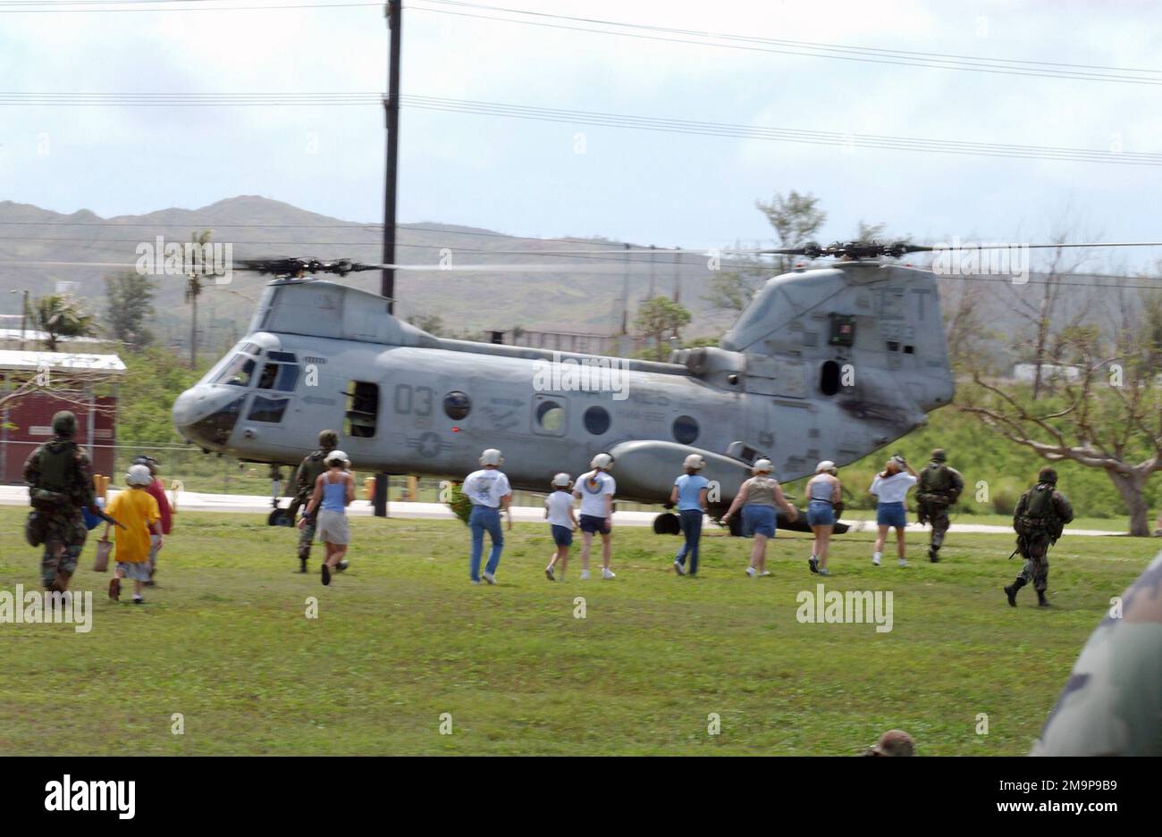 Civilian evacuees board a US Marine Corps (USMC) CH-46 Sea Knight ...