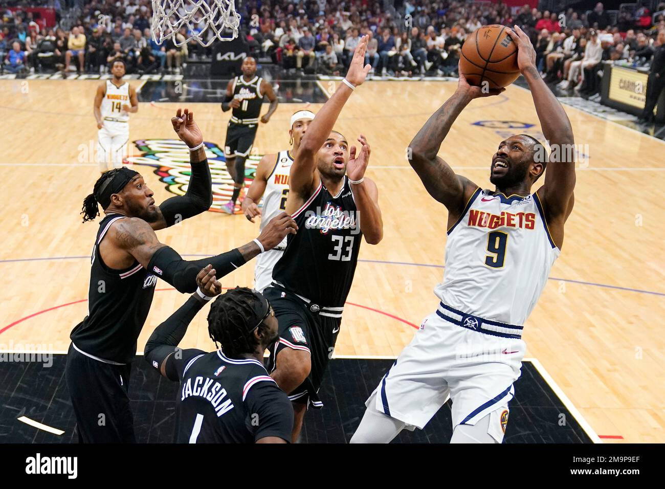 Denver Nuggets guard Davon Reed, right, shoots as Los Angeles Clippers forward Robert Covington ...