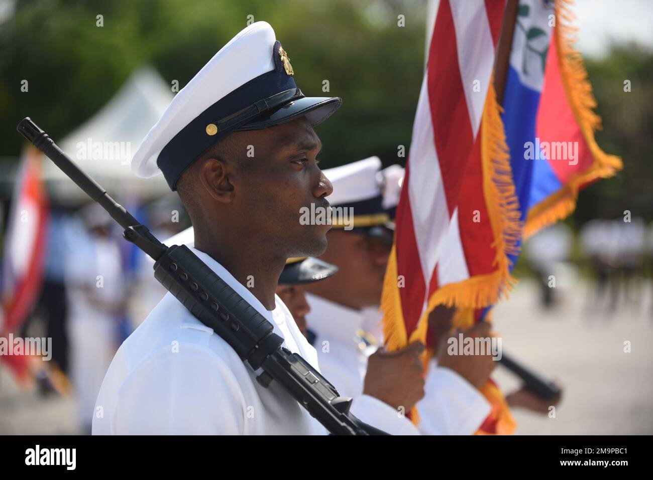 A member of the Belize coast guard stands at attention with the hosting ...