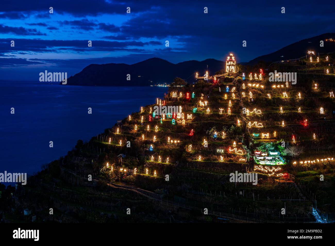 Illuminated Nativity Scene on the top of a Hill over the village of ...