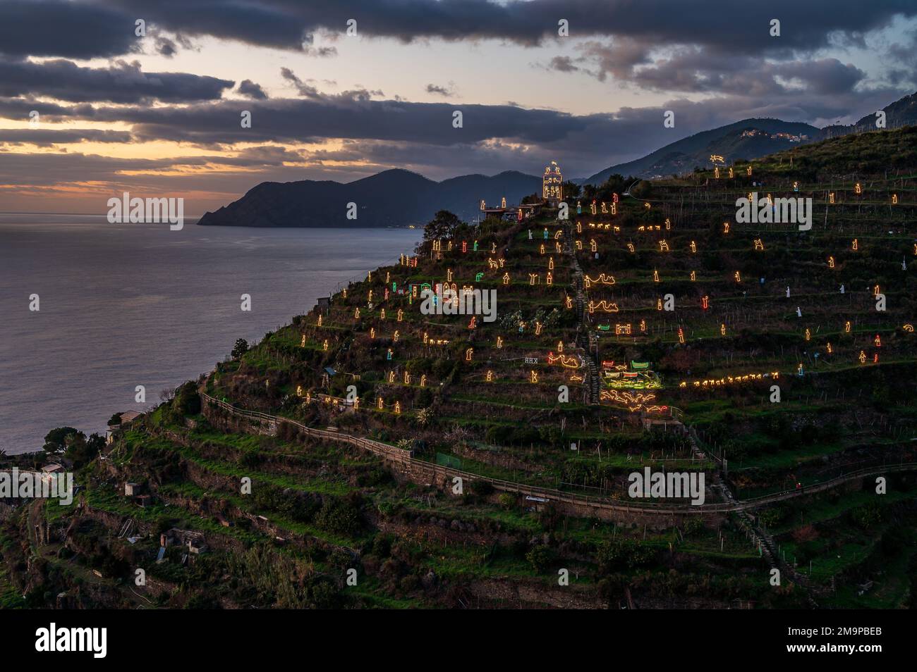 Illuminated Nativity Scene on the top of a Hill over the village of ...